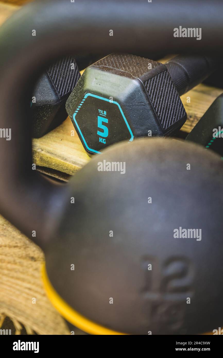 Set of dumbbells and kettlebells for weight training workout on a ...