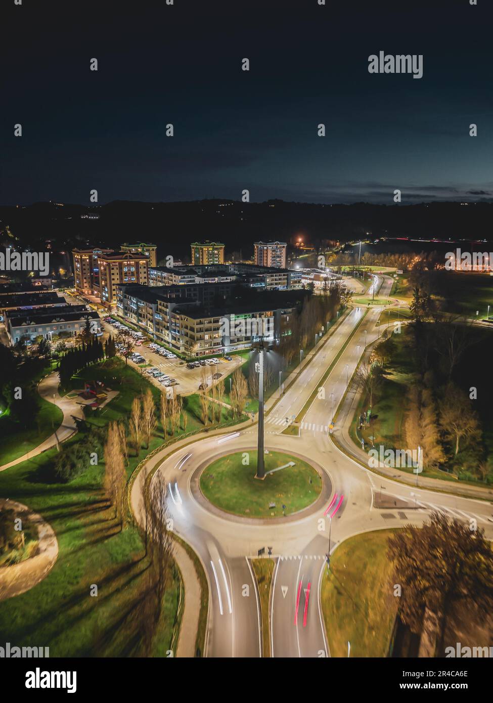 Nighttime urban cityscape of a busy street intersection with multiple ...