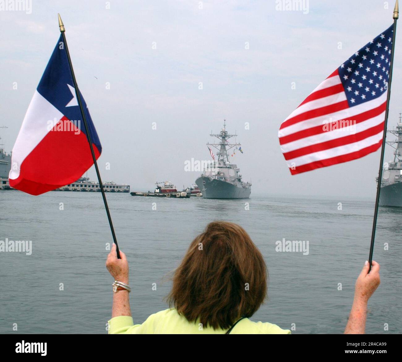 US Navy waves Texan and American flags as the guided-missile destroyer ...