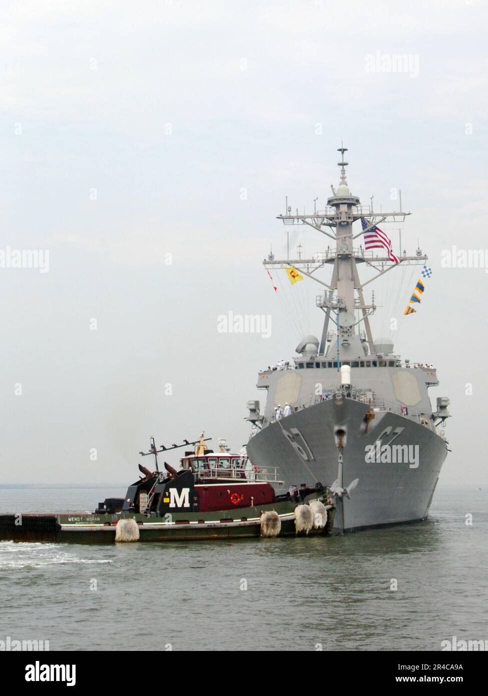 US Navy The guided-missile destroyer USS Cole (DDG 67) is tugged away ...