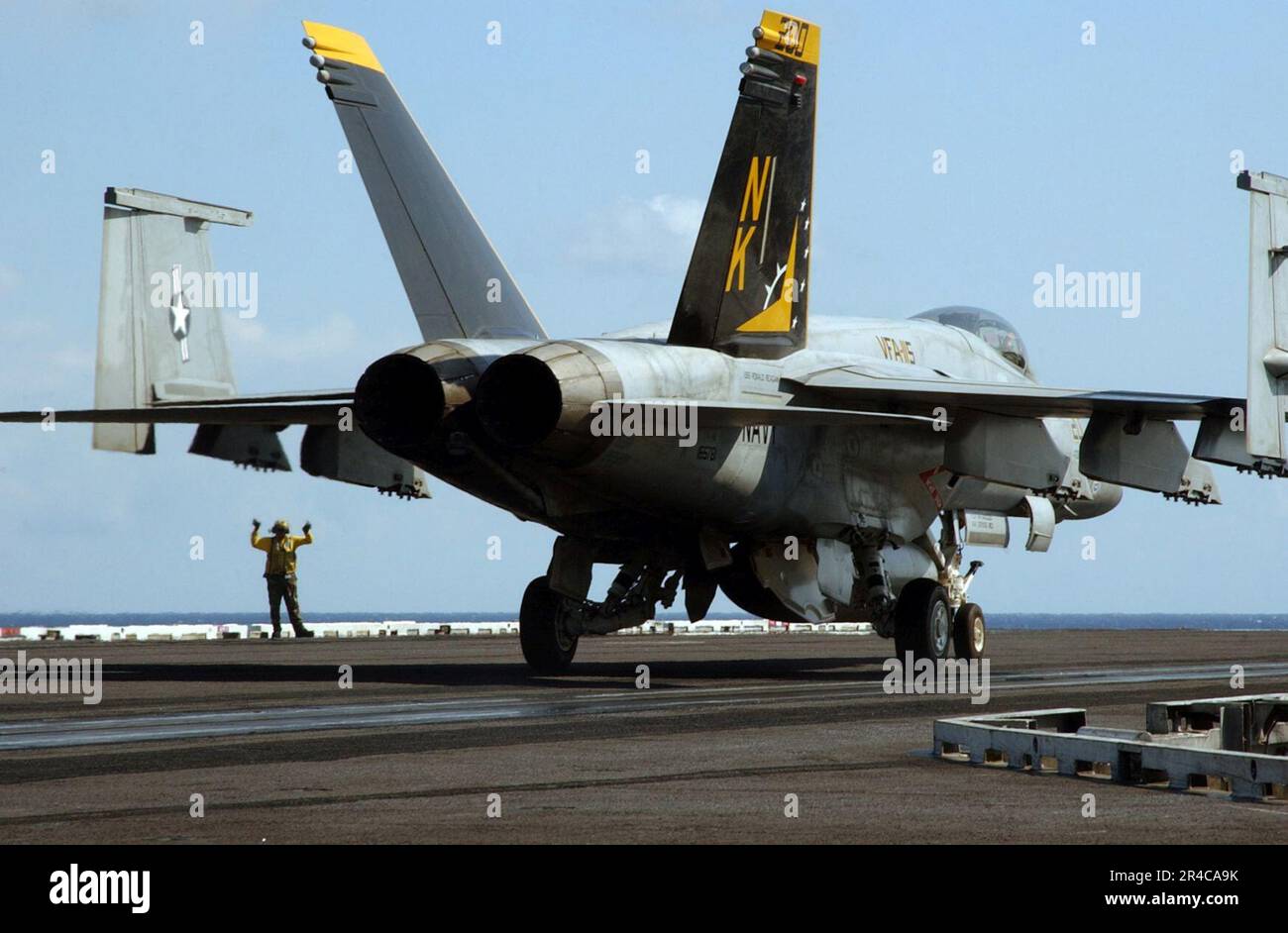 US Navy A plane director signals to an F-A-18E Super Hornet, assigned ...