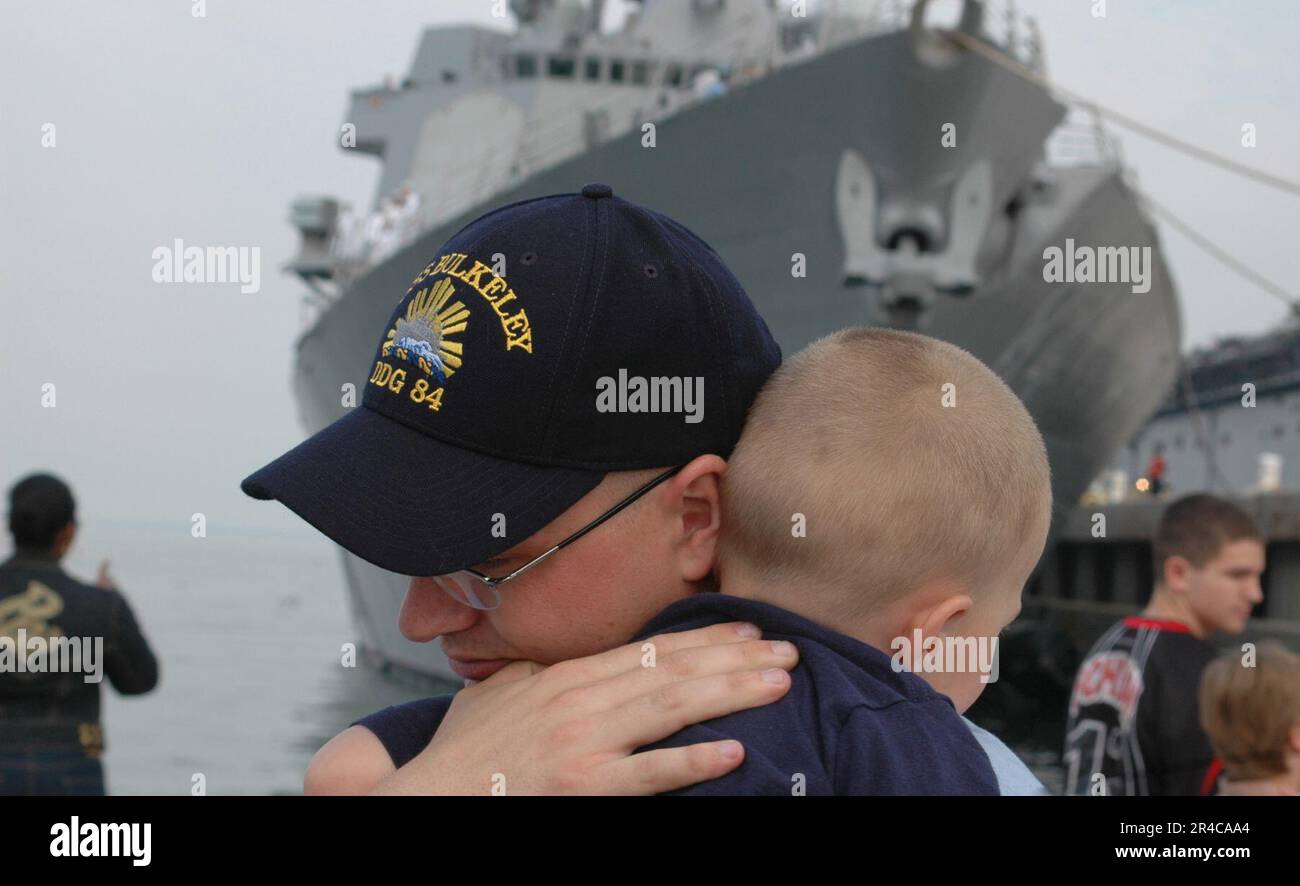 US Navy Electronics Technician 1st Class hugs his son, prior to ...