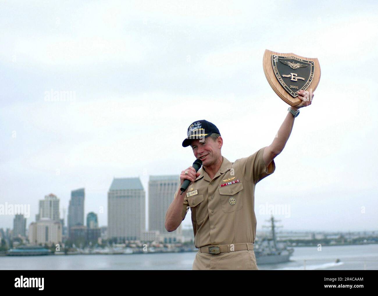 US Navy Commanding Officer Capt. holds up the 2005 Battle ''E'' Award ...