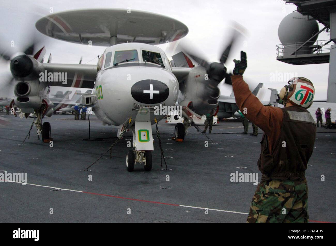 US Navy A plane captain assigned to the signals to the pilot of an E-2C ...