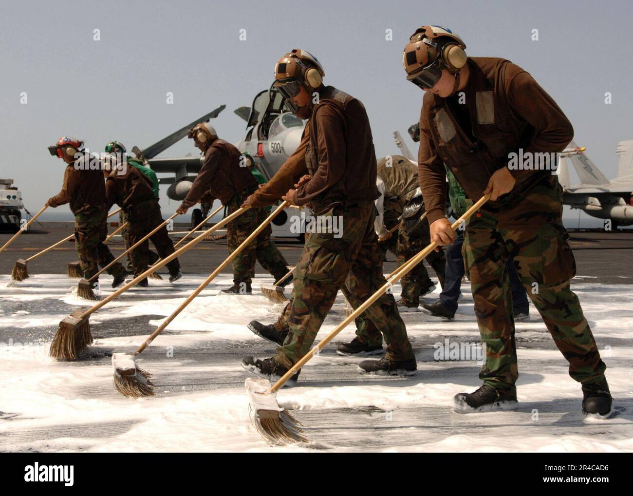 US Navy Sailors aboard the nuclear-powered aircraft carrier USS ...