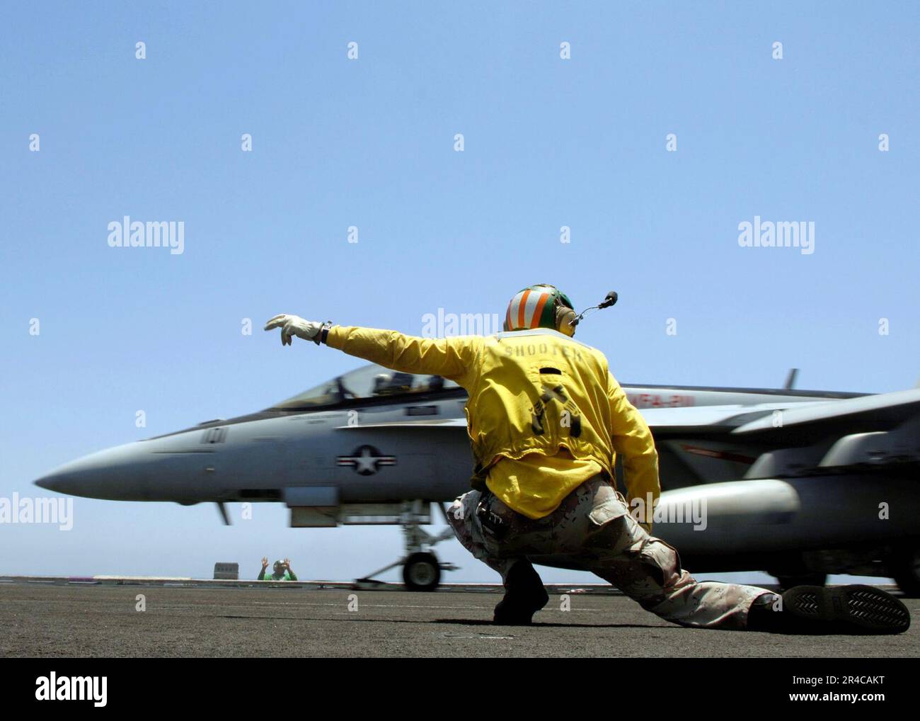 US Navy Catapult officer Lt. Cmdr. shoots an F-A-18F Super Hornet Stock ...