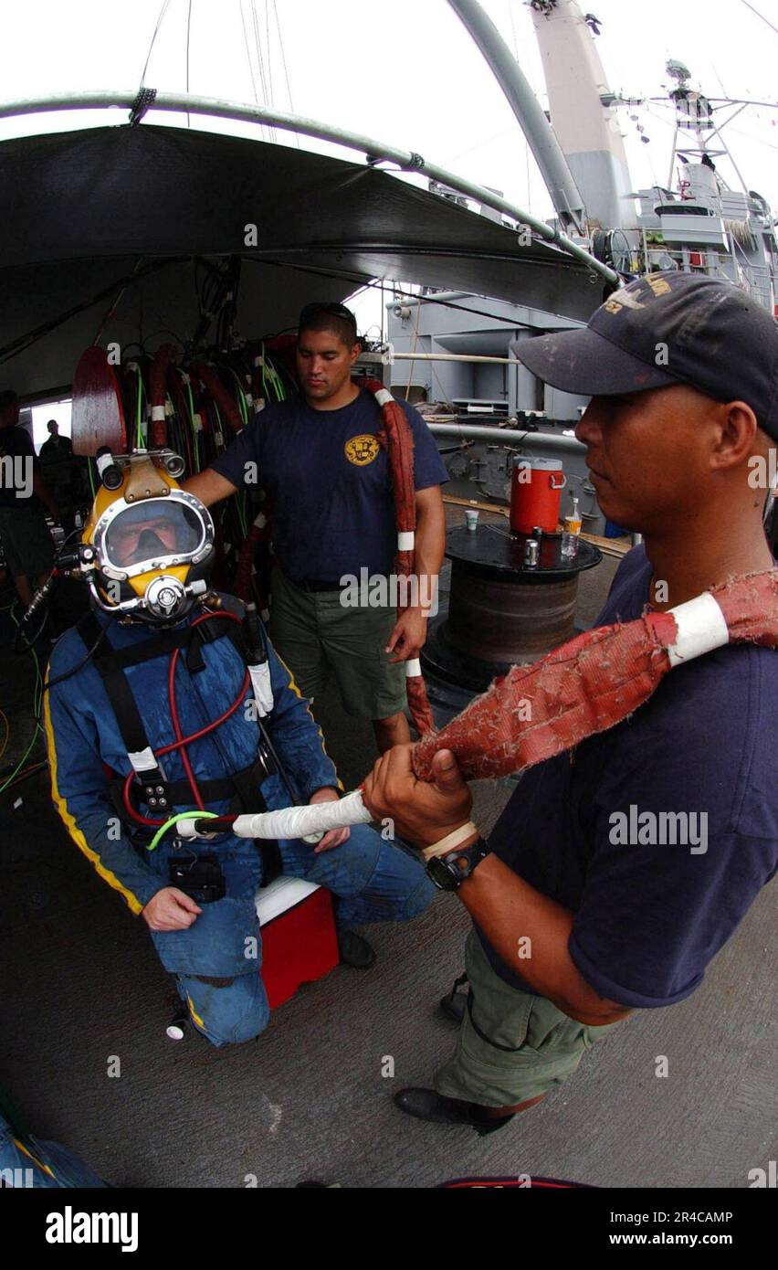 US Navy Chief Navy Diver stands by to be called to the stage aboard the ...