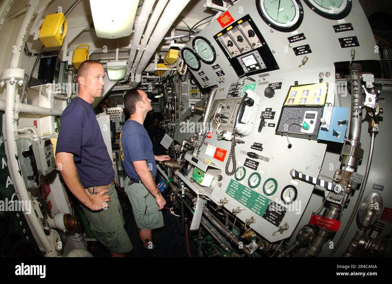 US Navy Chief Navy Diver and Navy Diver 1st Class monitor the surface ...