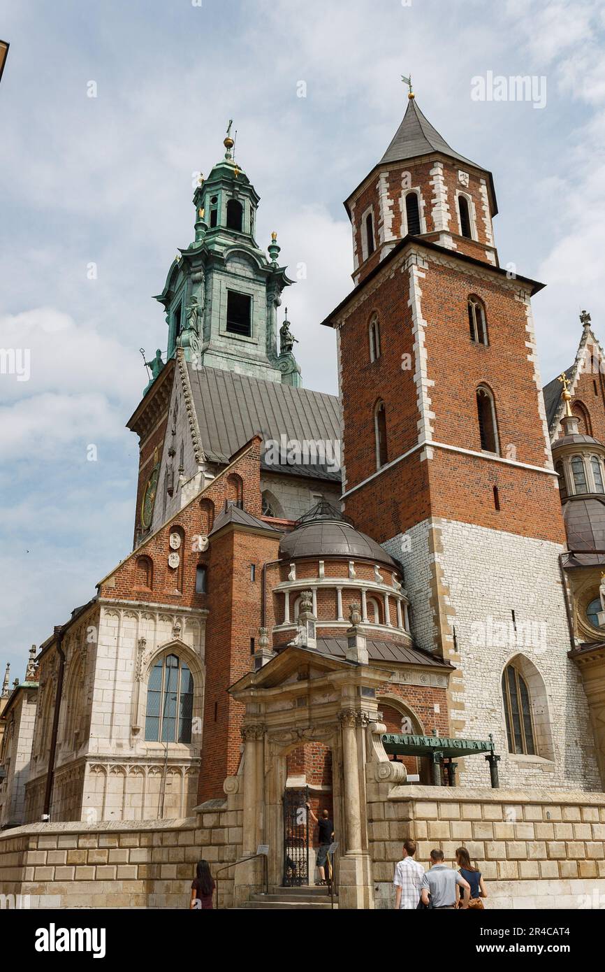 Two people stand in front of a traditional church building featuring ...