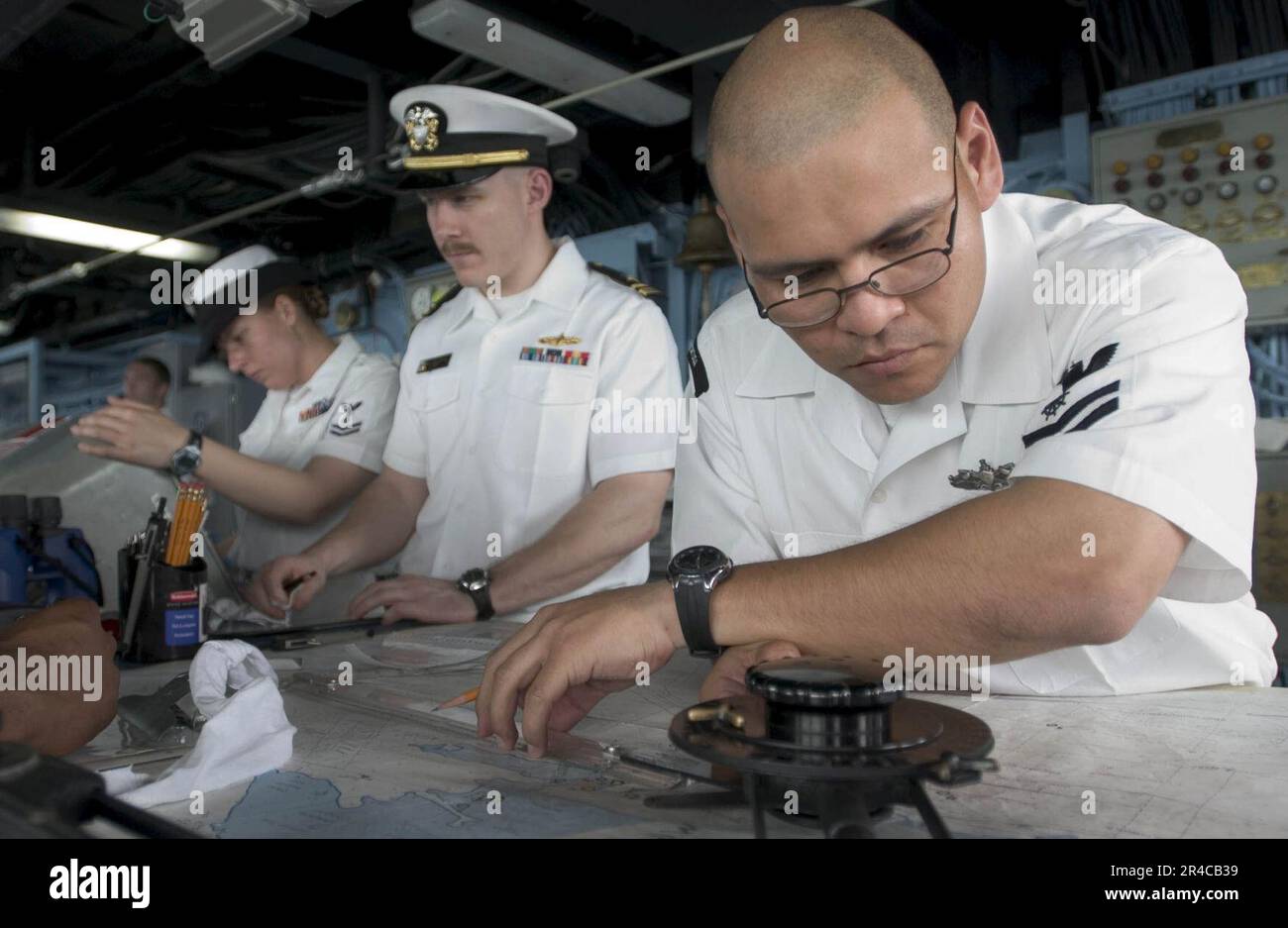 US Navy Quartermaster 2nd Class tracks the course of amphibious dock ...
