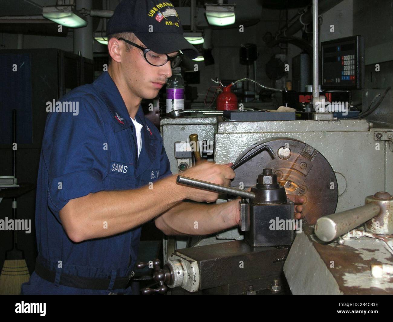 US Navy Machinery Repairman 2nd Class uses a milling machine to make a ...