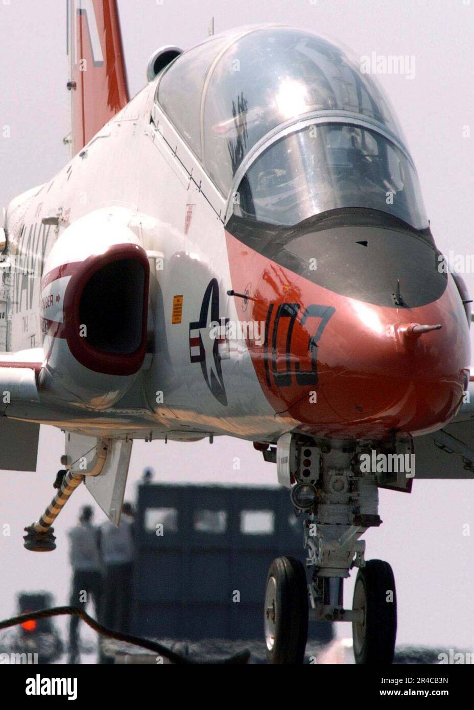 US Navy A naval aviator student releases the arresting wire from the ...