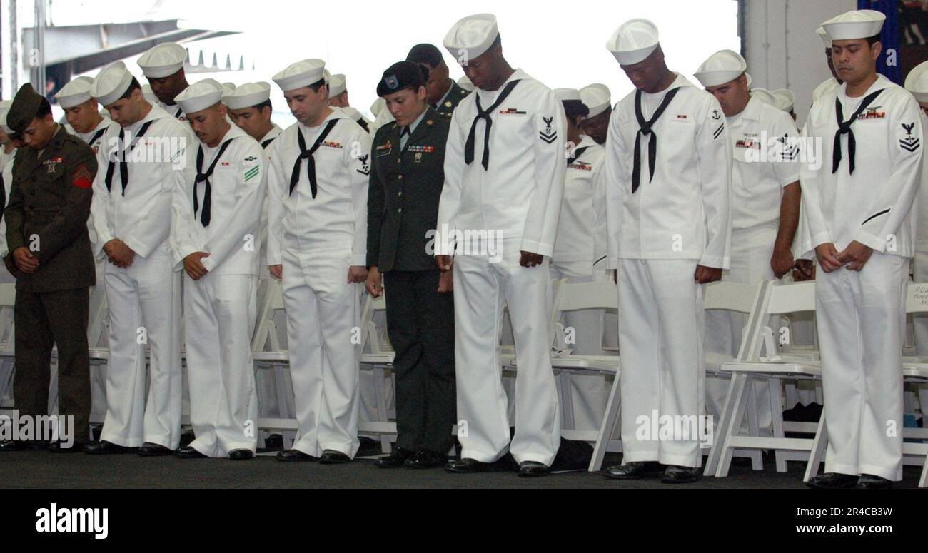 US Navy U.S. Sailors, Marines and Soldiers bow their heads in prayer at ...