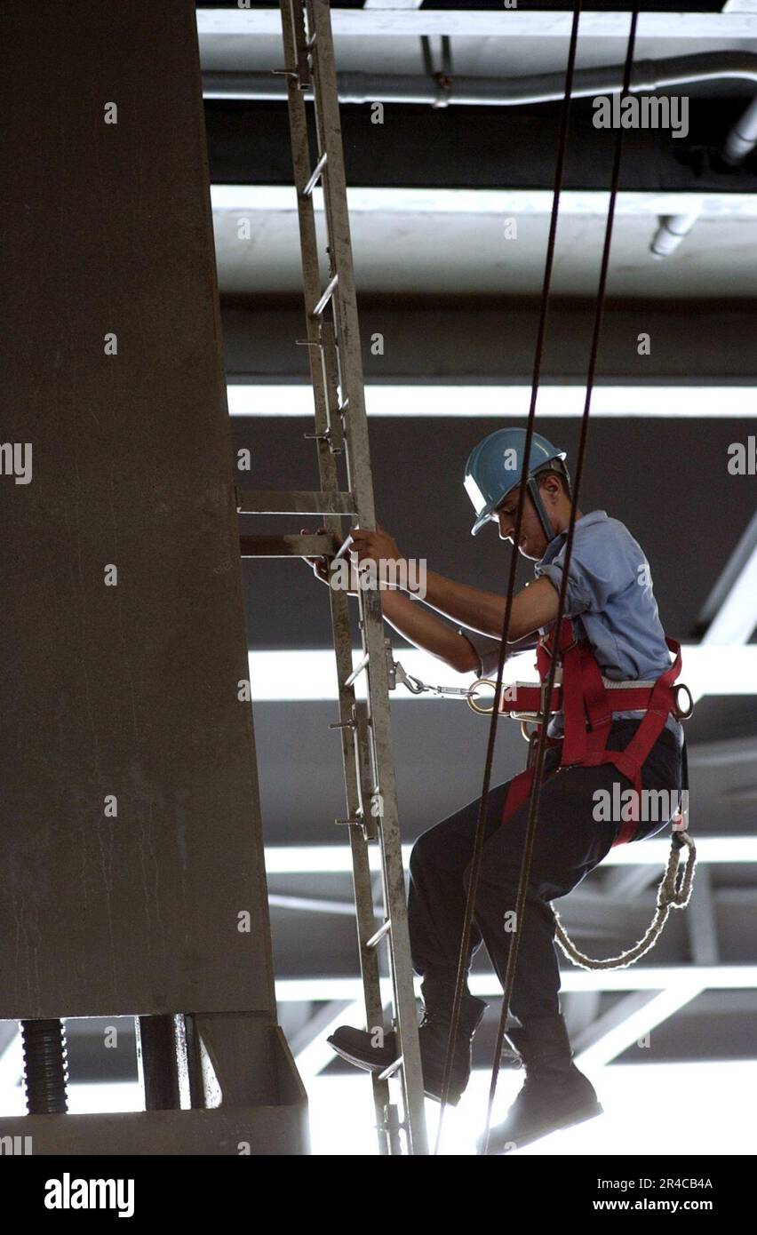 US Navy Seaman Derrick Allen from Cedar Hill, Texas, cautiously climbs ...