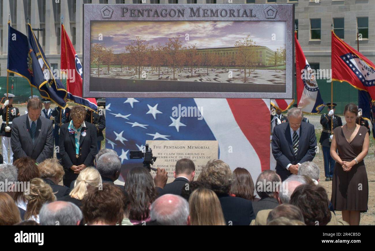 US Navy Ceremony participants stand in prayer during the benediction ...