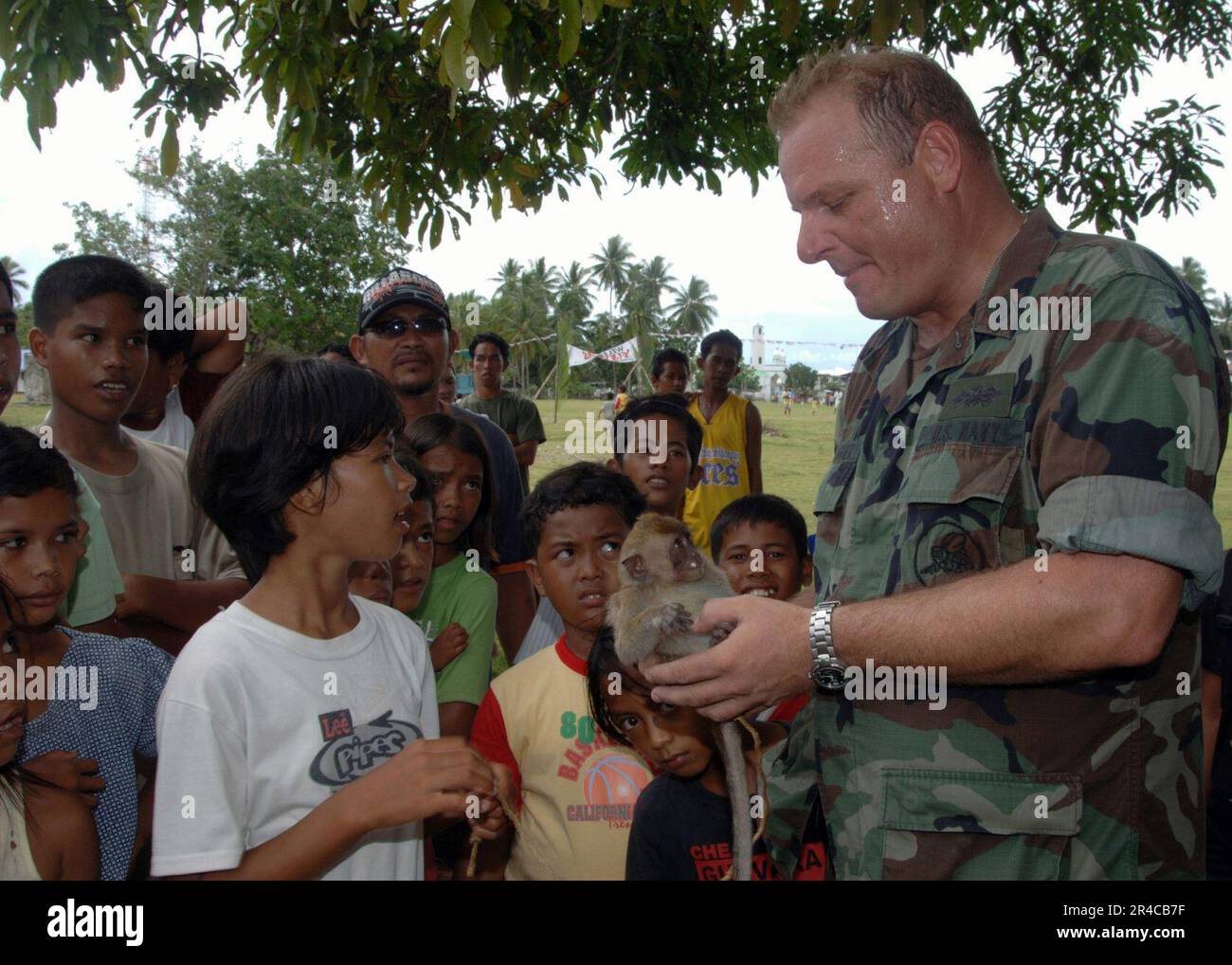 US Navy U.S. Navy Chief spends time with the domestic monkey of a small ...