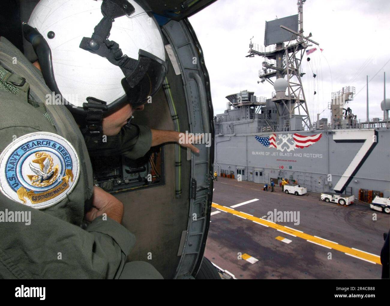 US Navy Aviation Warfare Technician 3rd Class spots a landing on the ...