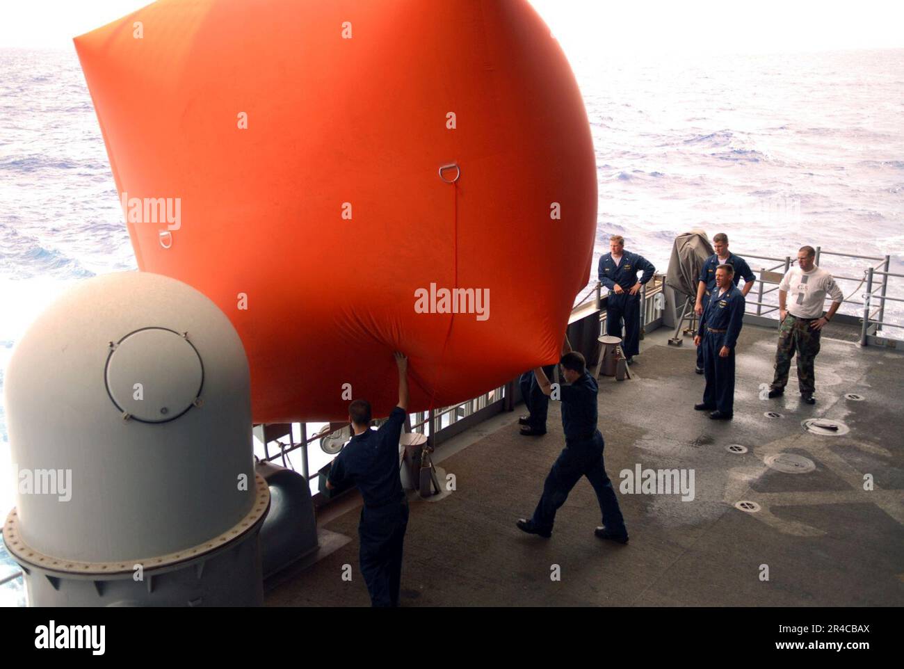 US Navy Weapons Department Sailors push an inflatable balloon used for ...