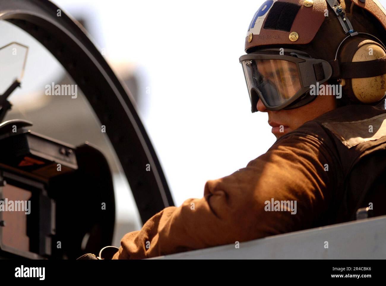 US Navy Airman sits in the cockpit of an F-A-18E Super Hornet assigned ...