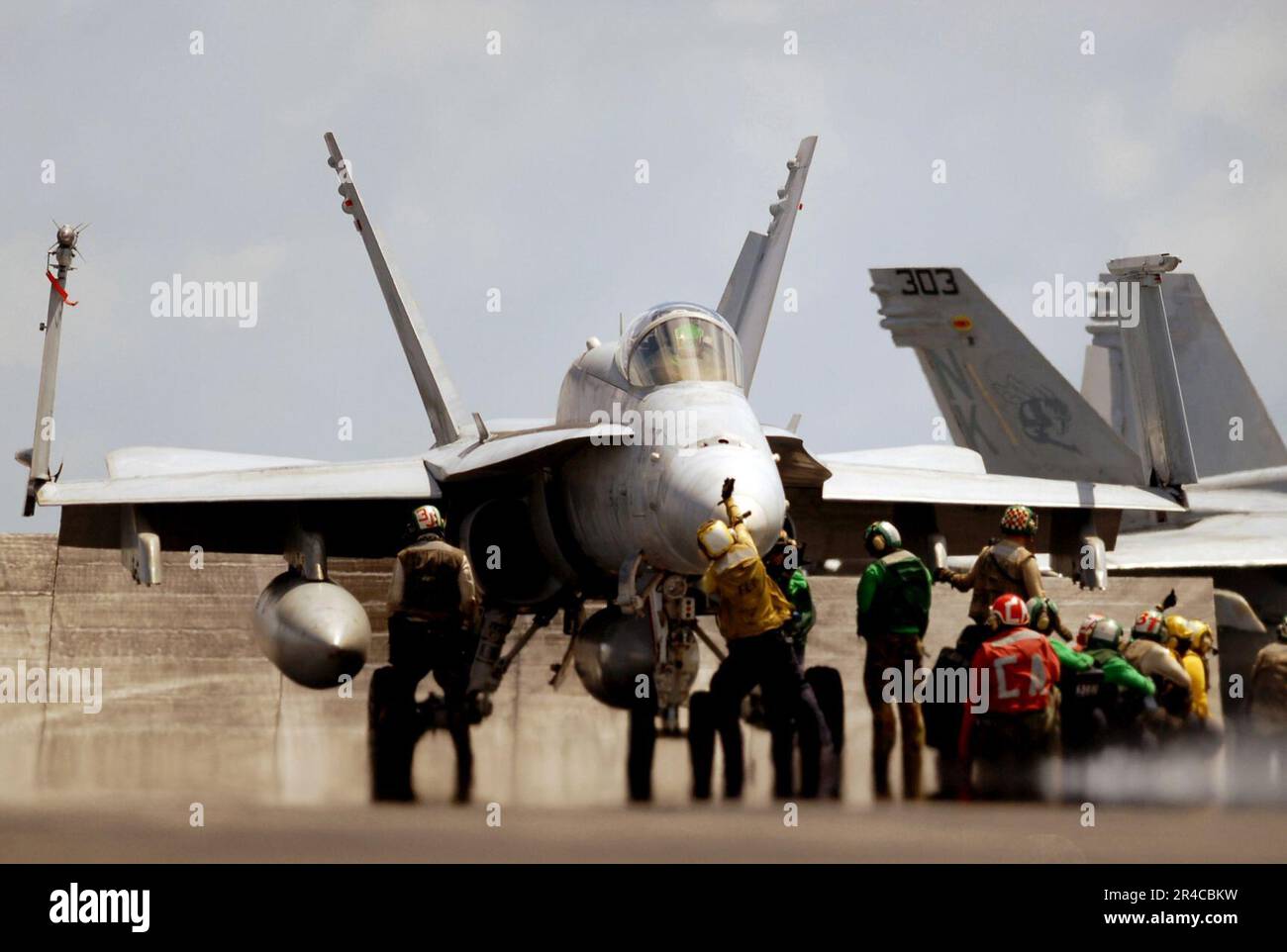 US Navy Flight deck personnel standby on the waist catapults on the ...