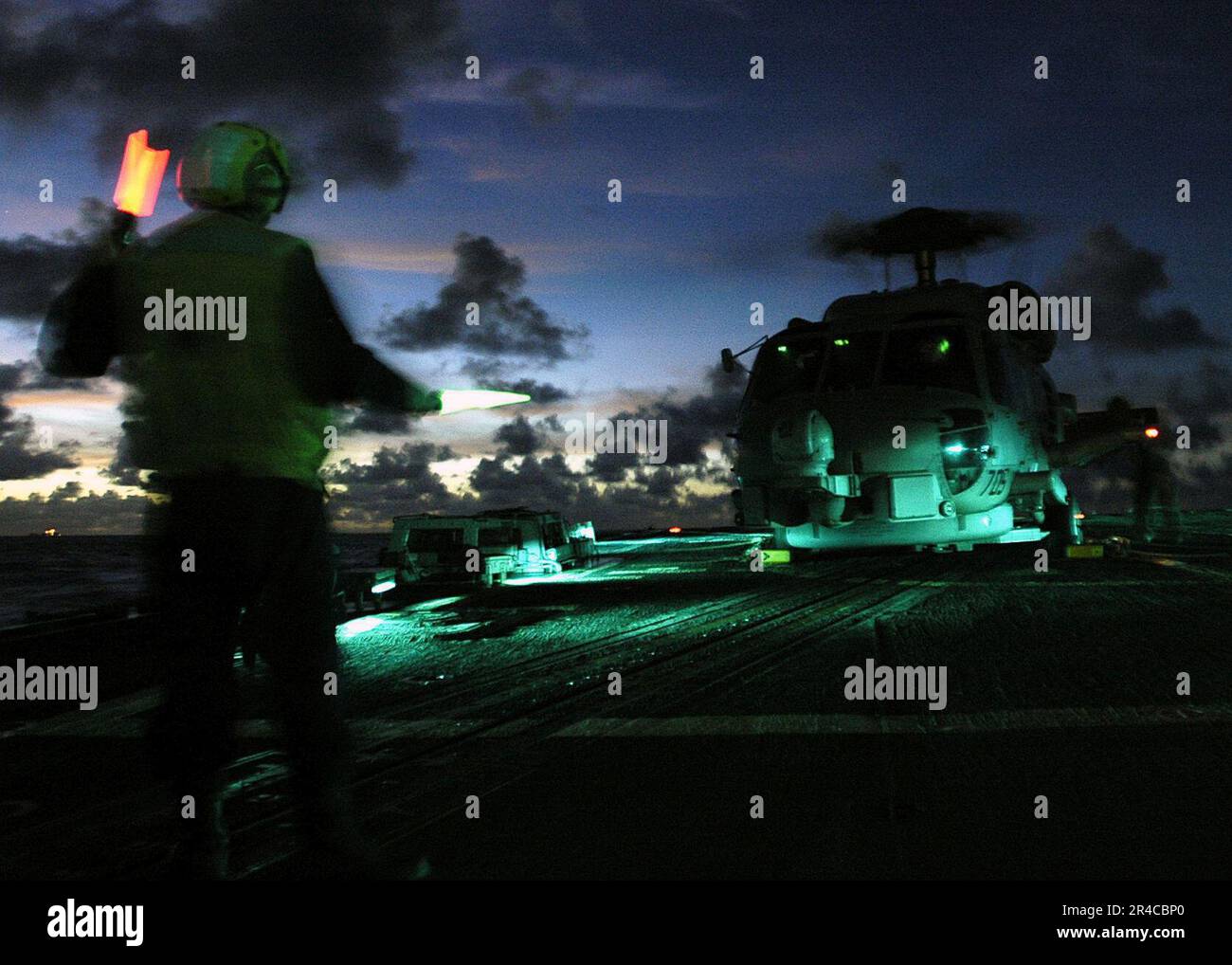 US Navy Boatswain's Mate 3rd Class prepares to launch a SH-60B Seahawk ...