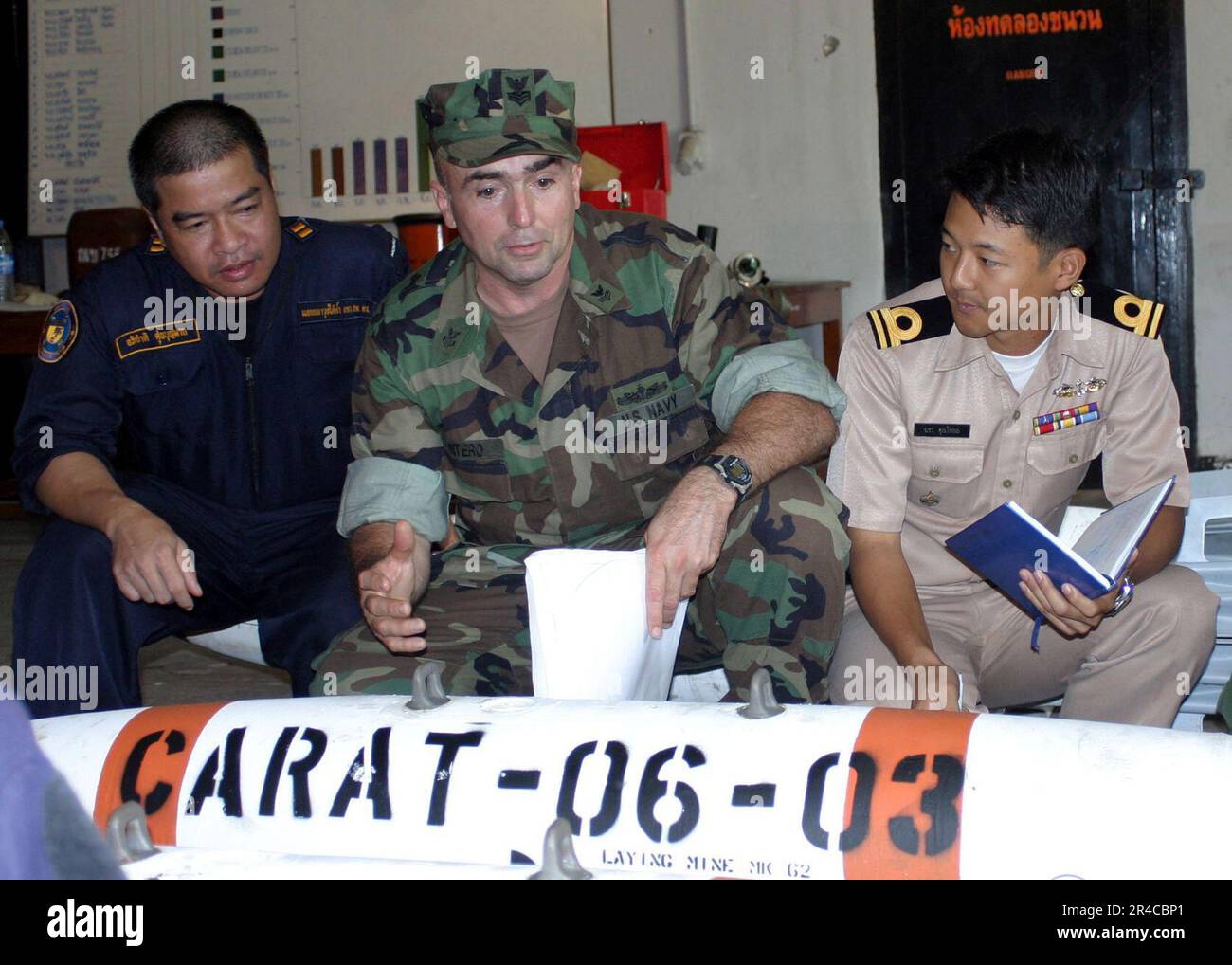 US Navy Mineman 1st Class assigned to Mobile Mine Assembly Unit Ten (MOMAU-10) explains the ...