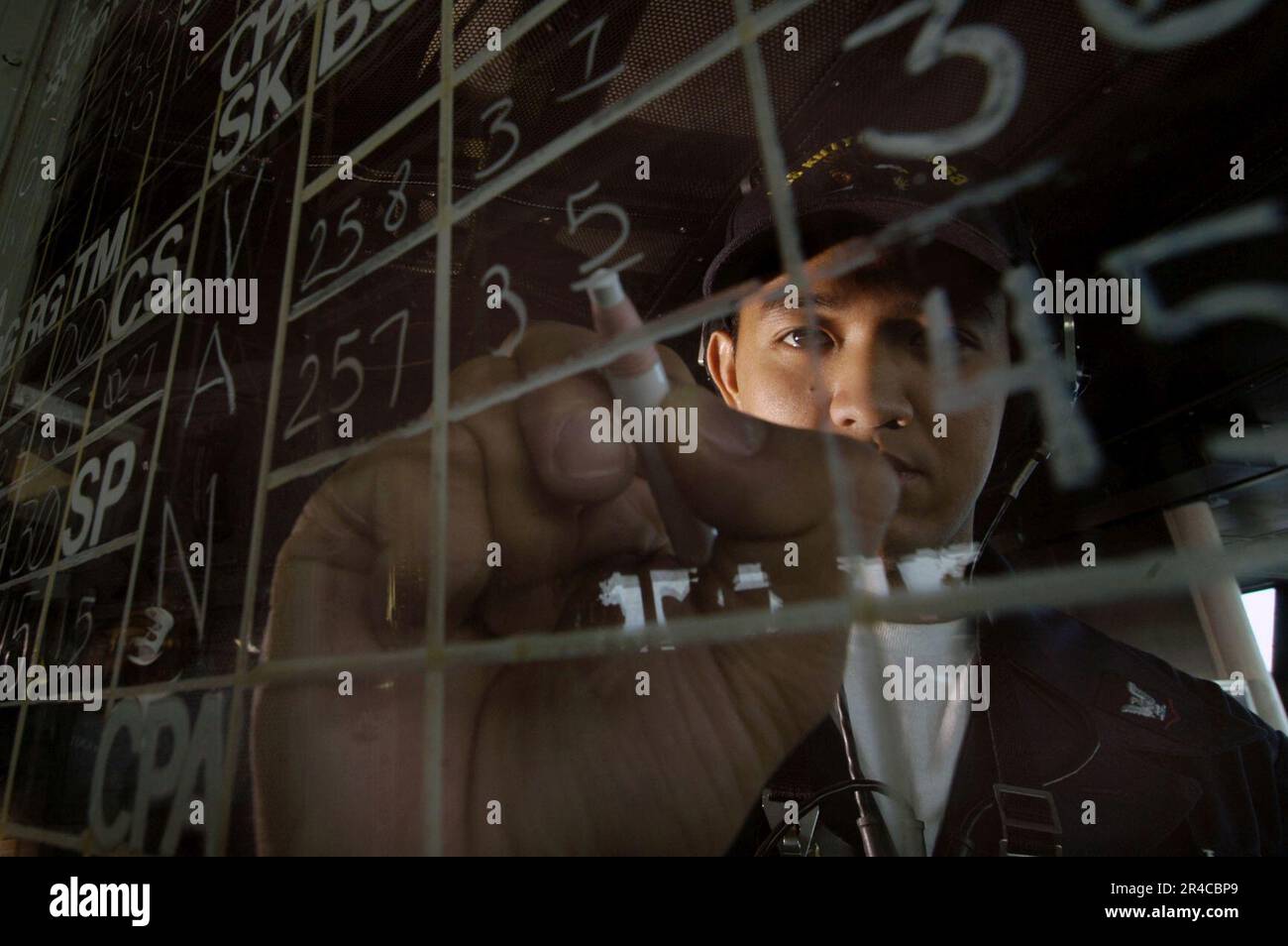 US Navy Operations Specialist 3rd Class keeps track of nearby ships on ...
