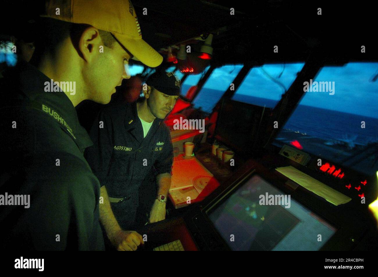 US Navy Lt. instructs Ensign on watch standing duties as officer of the ...