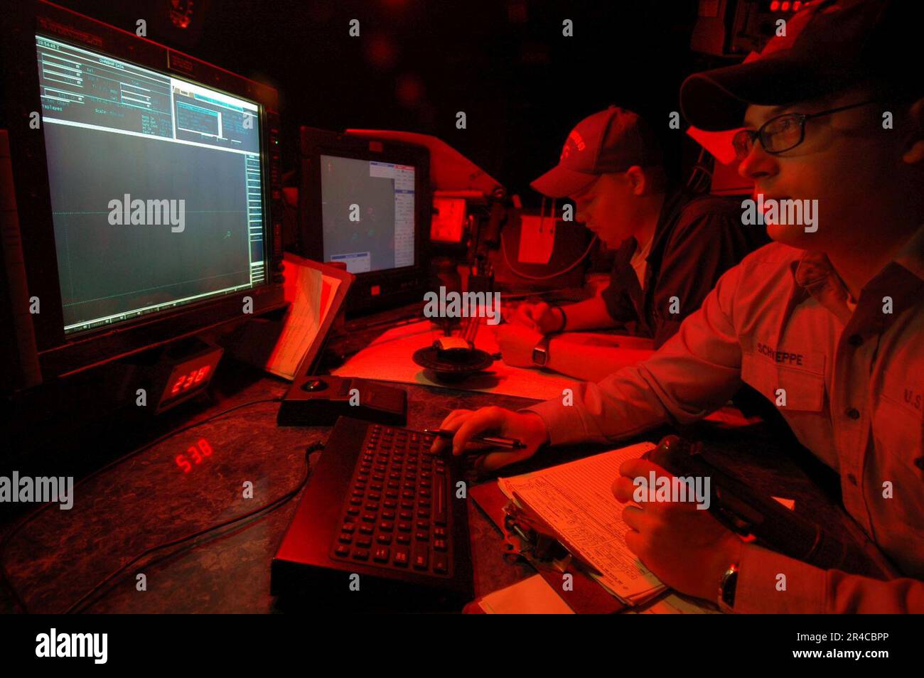 US Navy Quartermaster Seamen perform navigational duties on the bridge ...