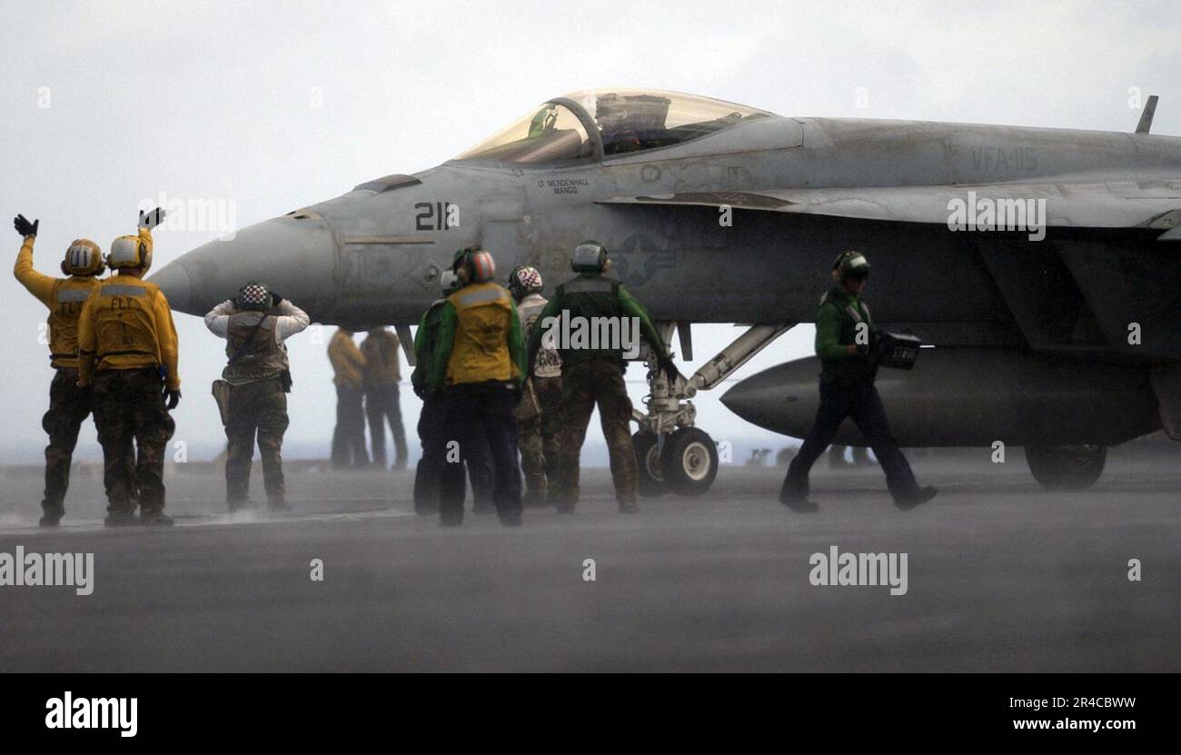 US Navy Flight deck personnel prepare an F-A-18E Super Hornet for ...