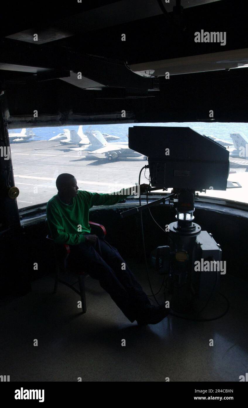 US Navy Fireman stands watch with the camera overlooking flight ...