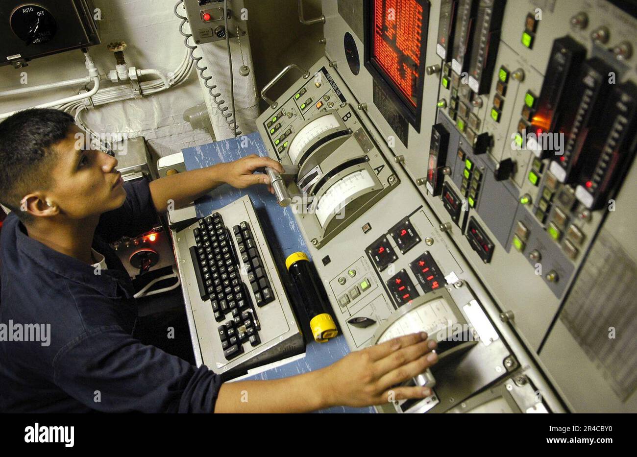 US Navy Gas Turbine Technician Mechanical Fireman monitor the main ...