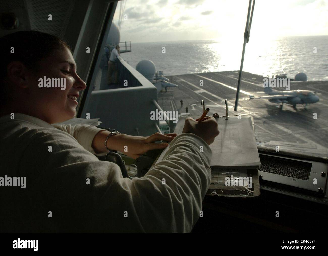 US Navy Aviation Boatswain's Mate Airman writes down information on an ...