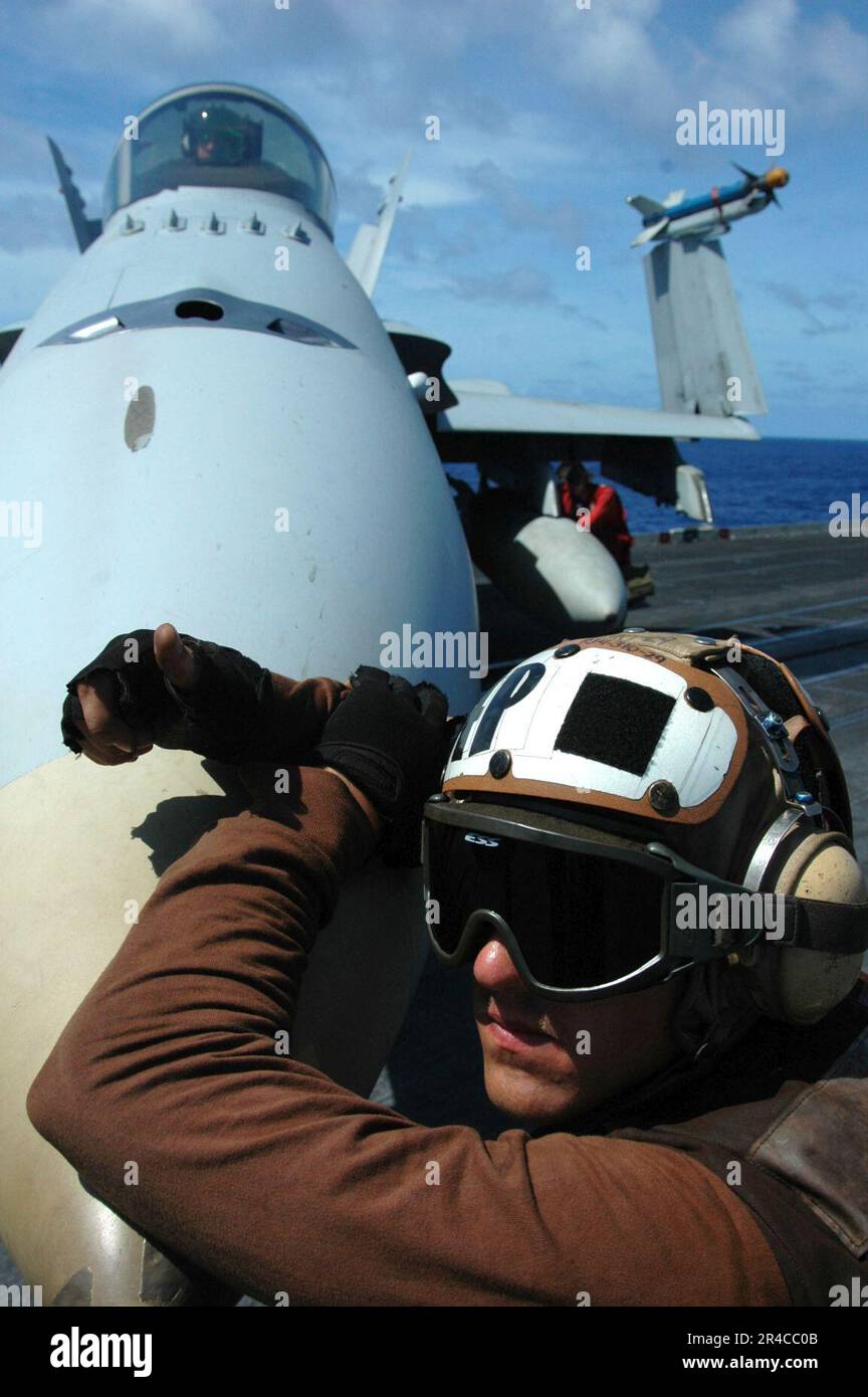 US Navy A Sailor assigned to Carrier Air Wing Five (CVW-5) leans on an ...