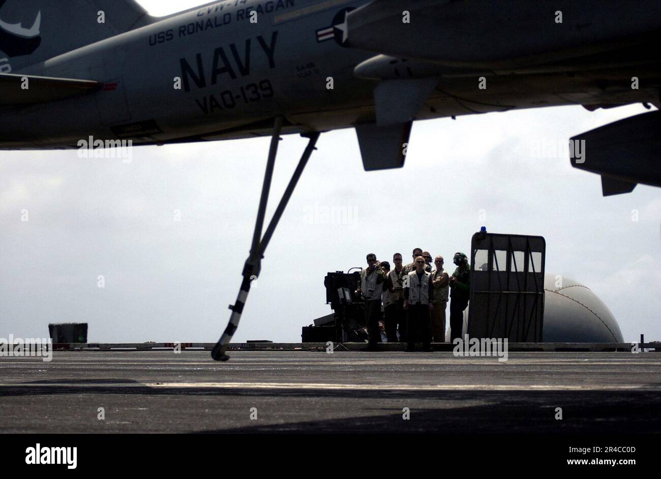 US Navy With landing signal officers looking on from their platform, an ...