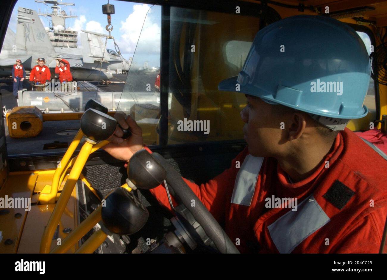 US Navy Fire Controlman 2nd Class keeps his eyes on the signalman while ...