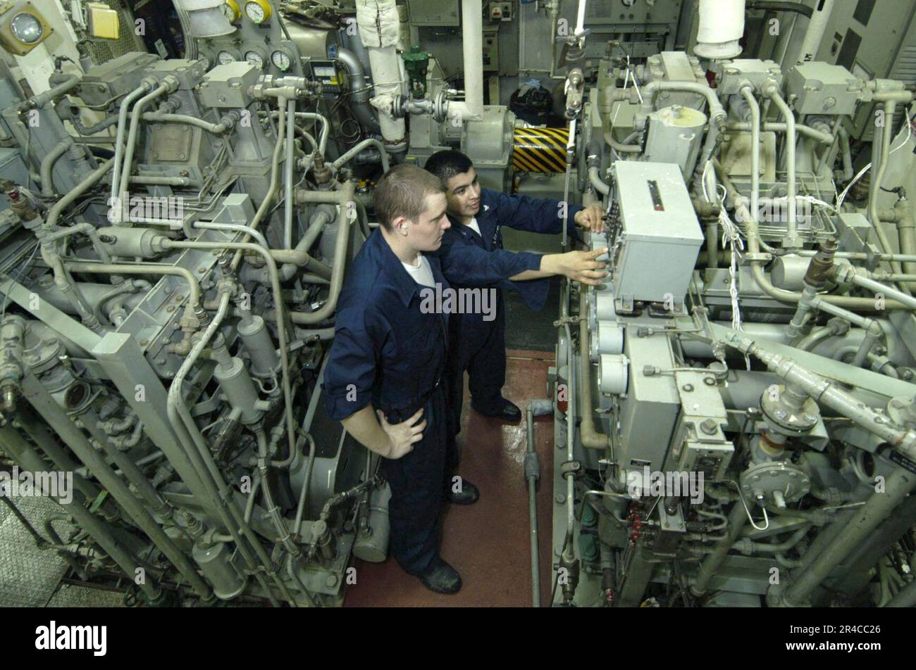 US Navy Machinist's Mate 3rd Class and Machinist's Mate Fireman inspect ...