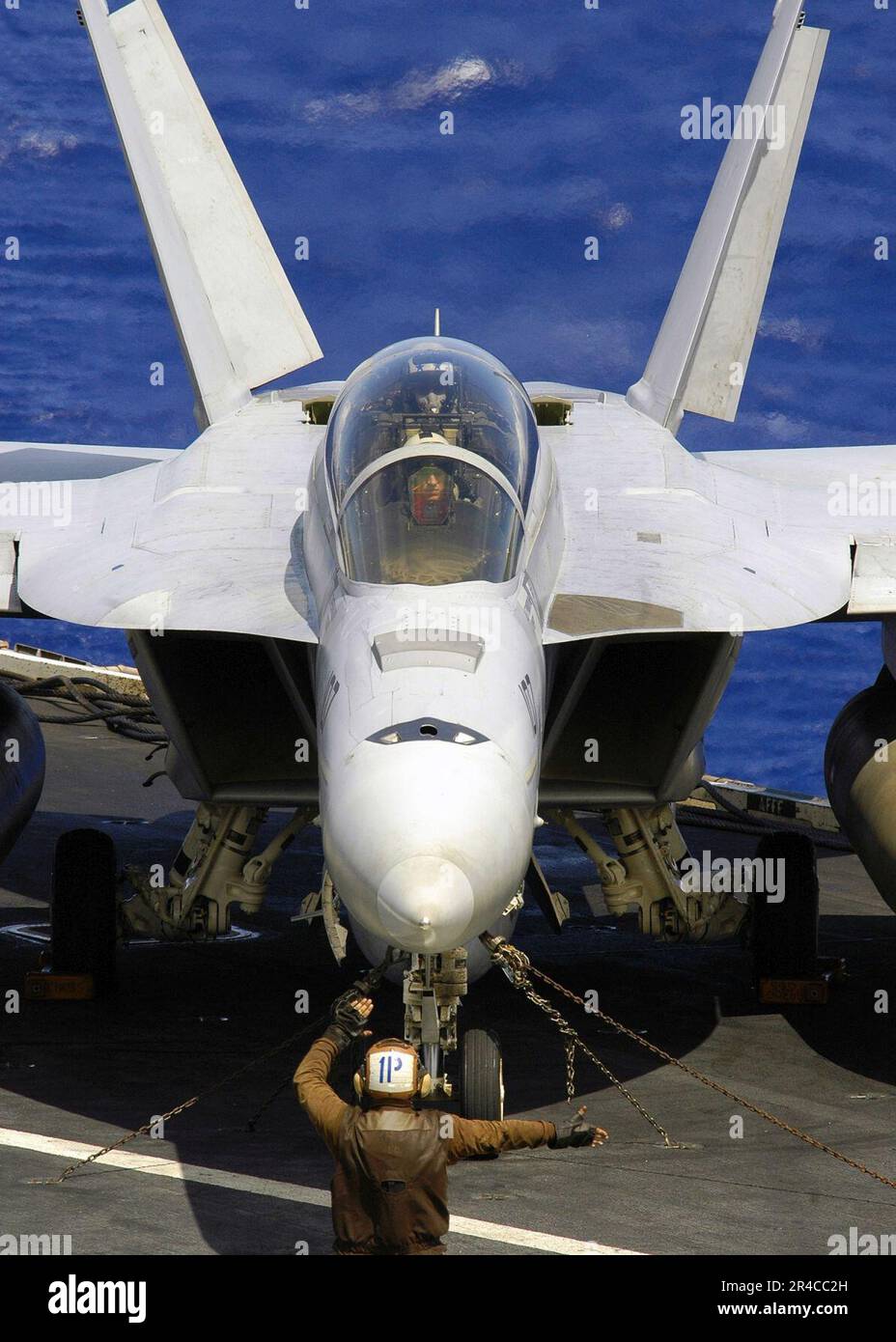 US Navy A plane captain directs an F-A-18F Super Hornet aircrew as they ...