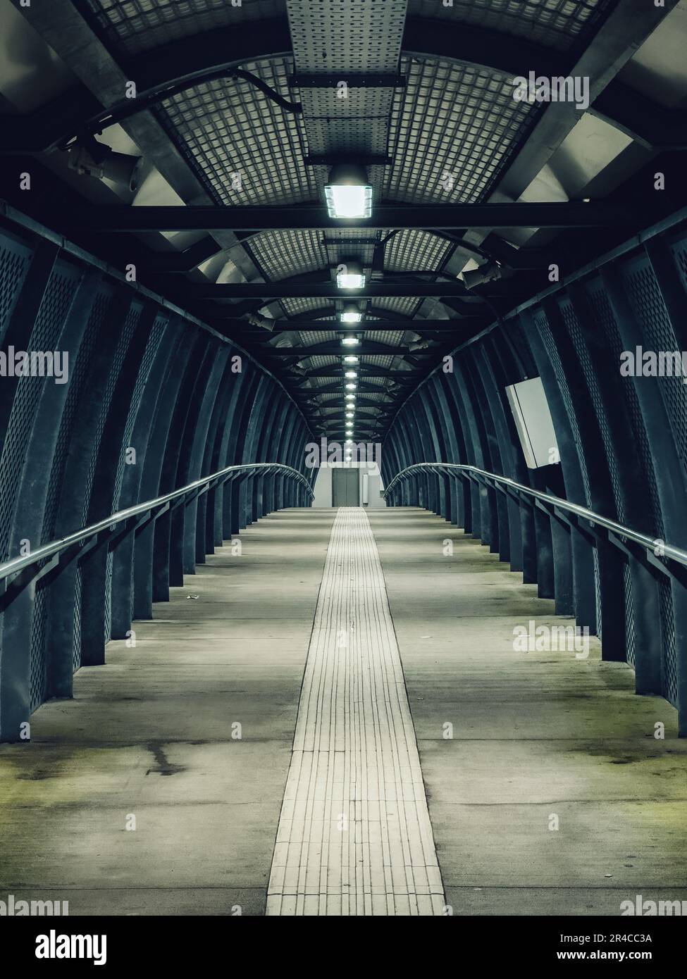 An overhead view of a concrete pathway leading up to a long building ...