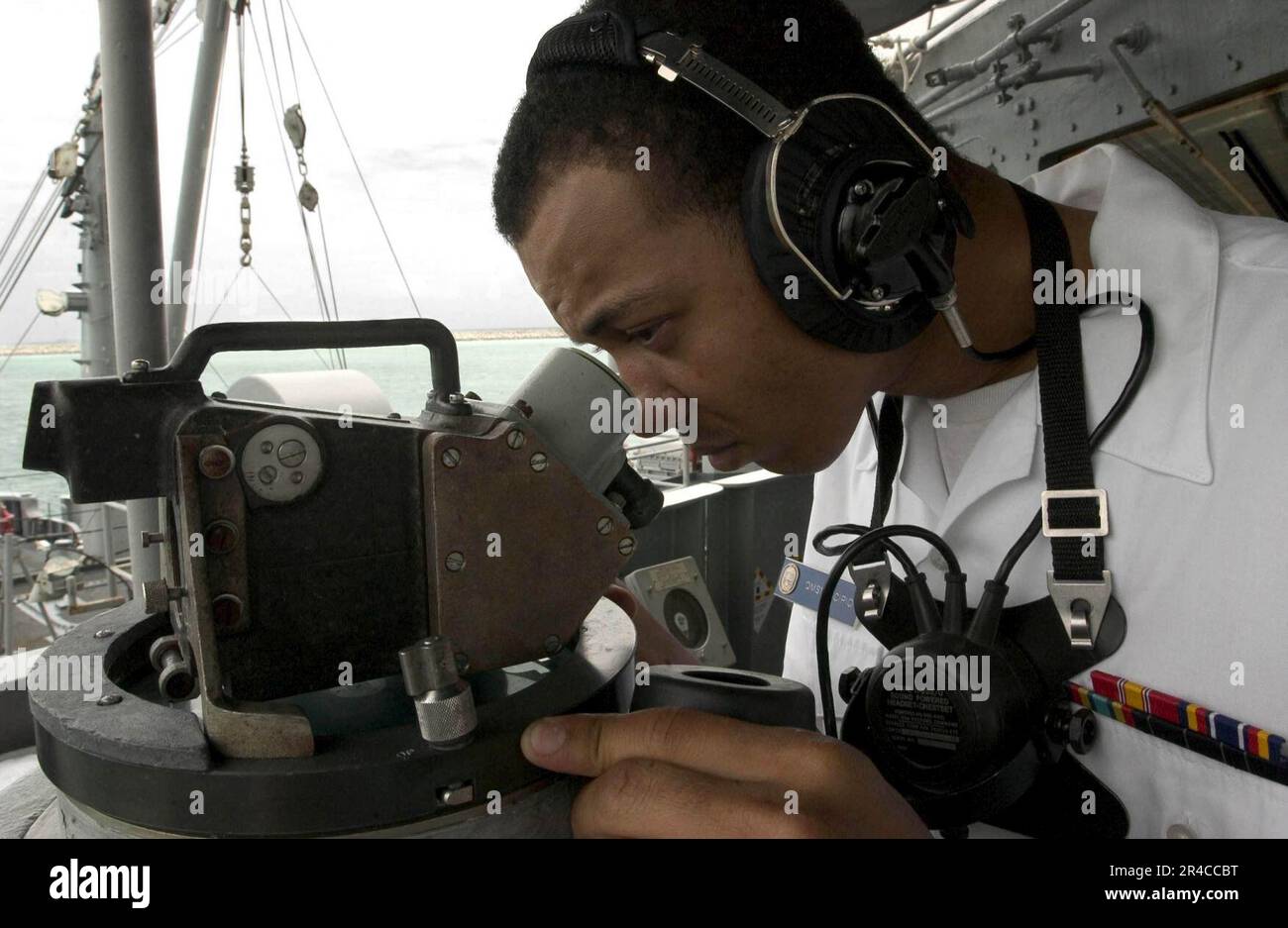 US Navy Quartermaster Seaman reads the ship's bearings as the rescue ...
