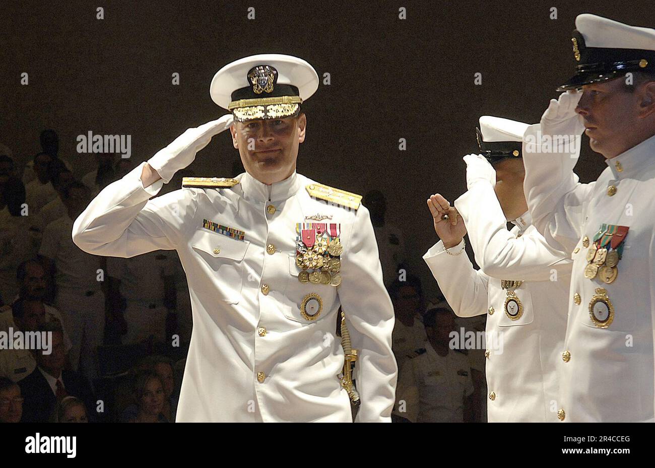 US Navy Rear Adm. Jeffrey L. Fowler salutes while departing through ...