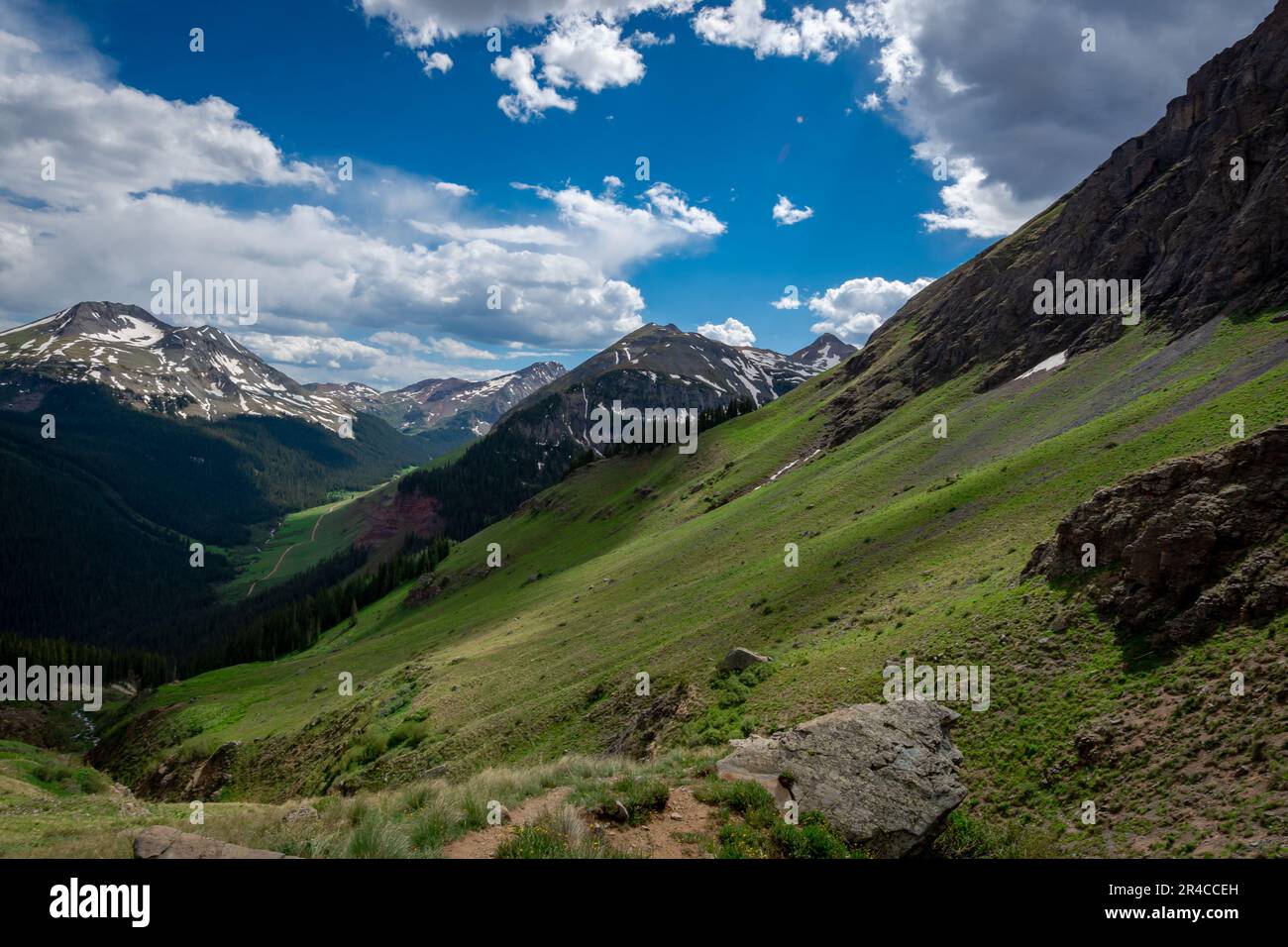A scenic mountainous landscape featuring rocky terrain and lush green ...