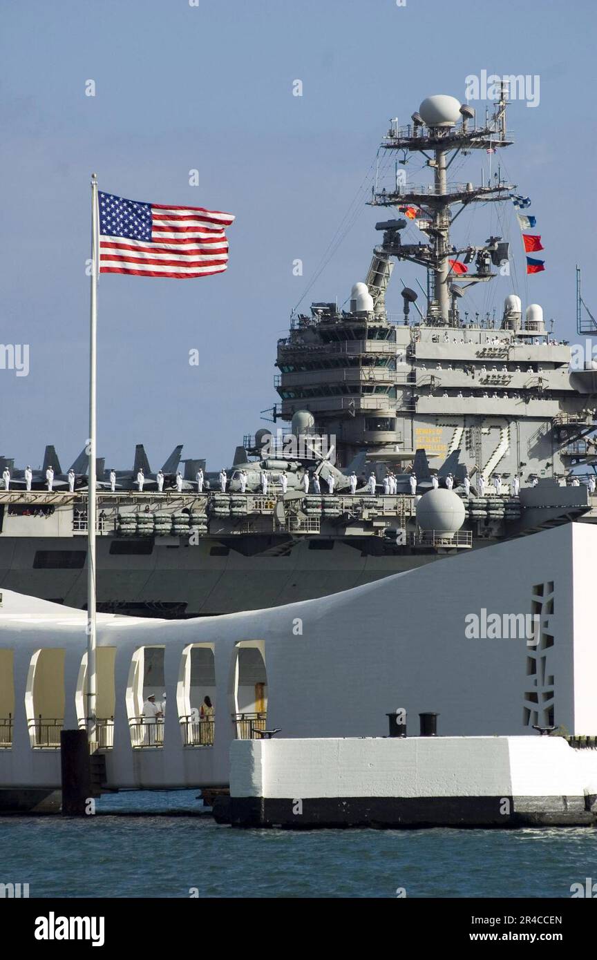 US Navy USS Abraham Lincoln (CVN 72) passes the USS Arizona Memorial as ...