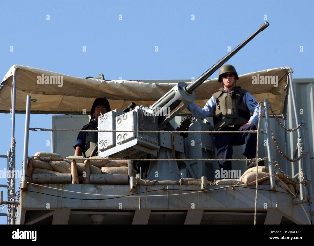 US Navy Crewmembers aboard USS Nashville (LPD 13) man a MK-38 25-mm ...
