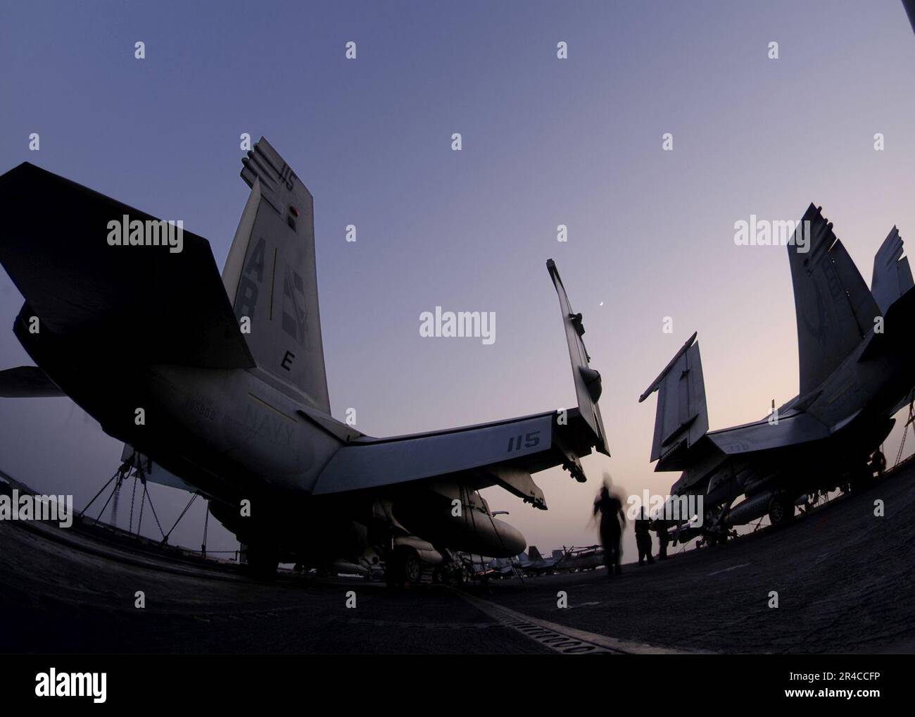 US Navy Flight deck personnel secure aircraft to the deck as the ...