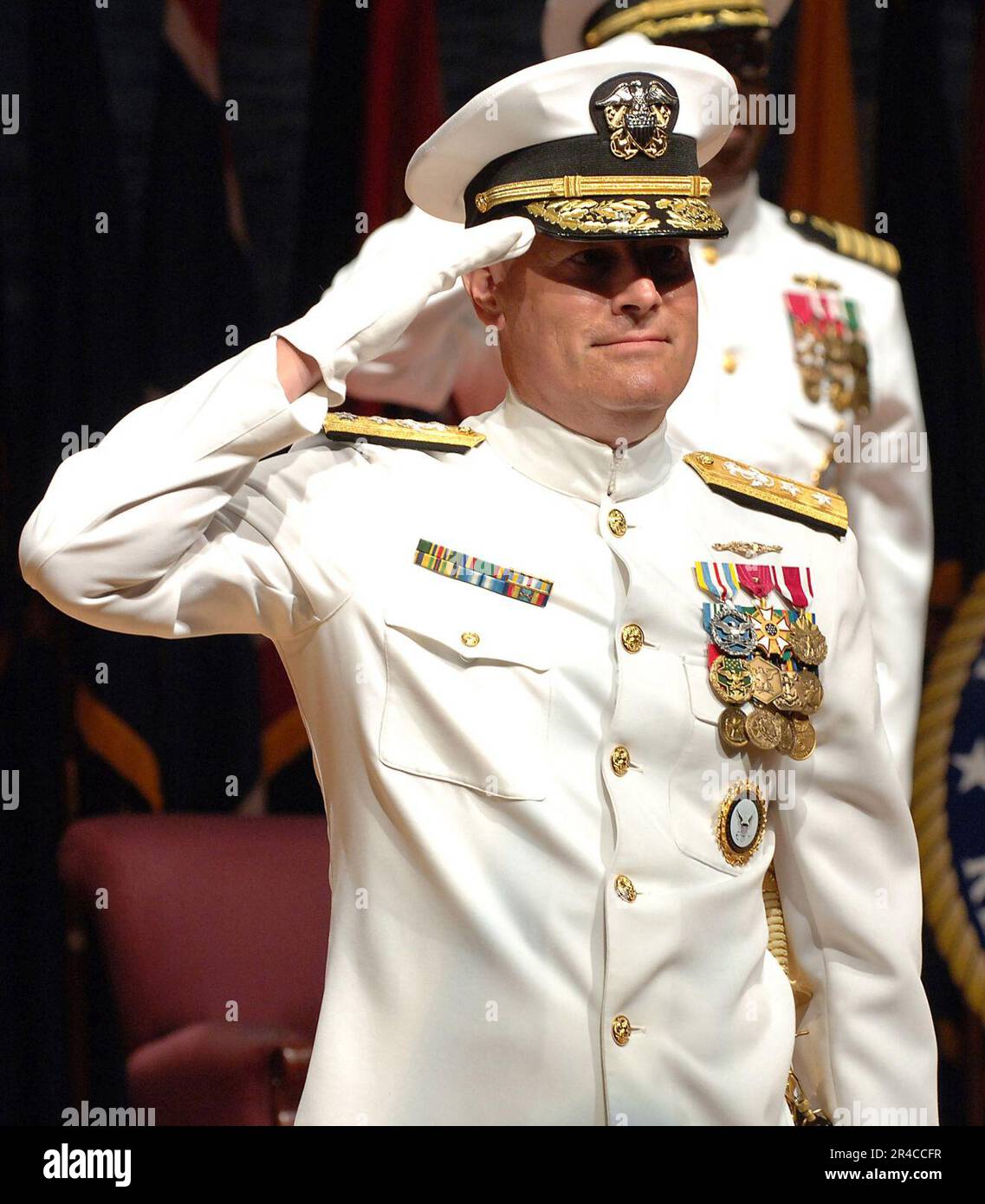 US Navy Rear ADM. Jeffrey L. Fowler salutes the troops at the Change of ...