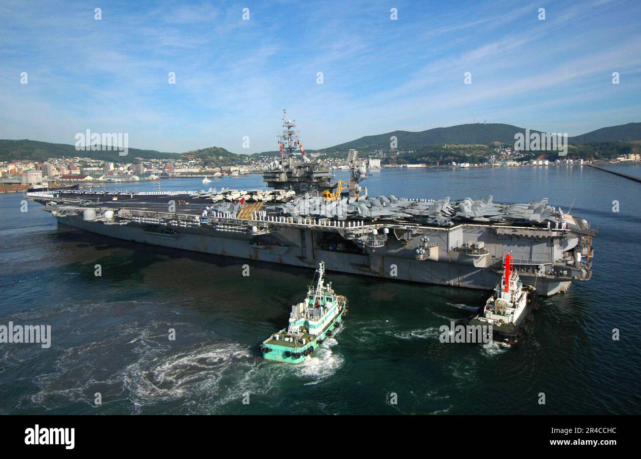 US Navy USS Kitty Hawk (CV 63) prepares to pull into Otaru, Japan for a ...