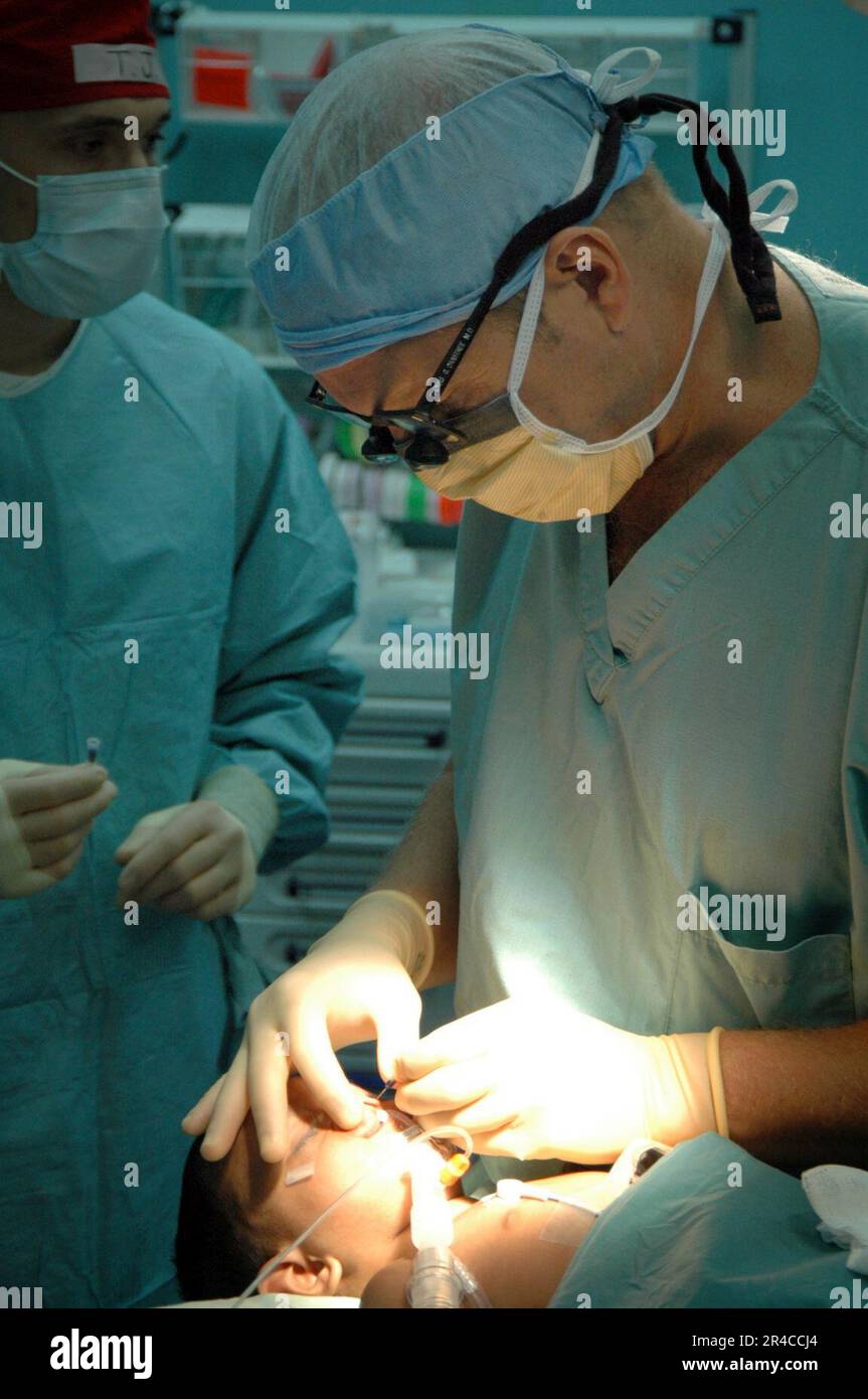 US Navy U.S. Army Col. and a Operation Smile volunteer, perform cleft ...