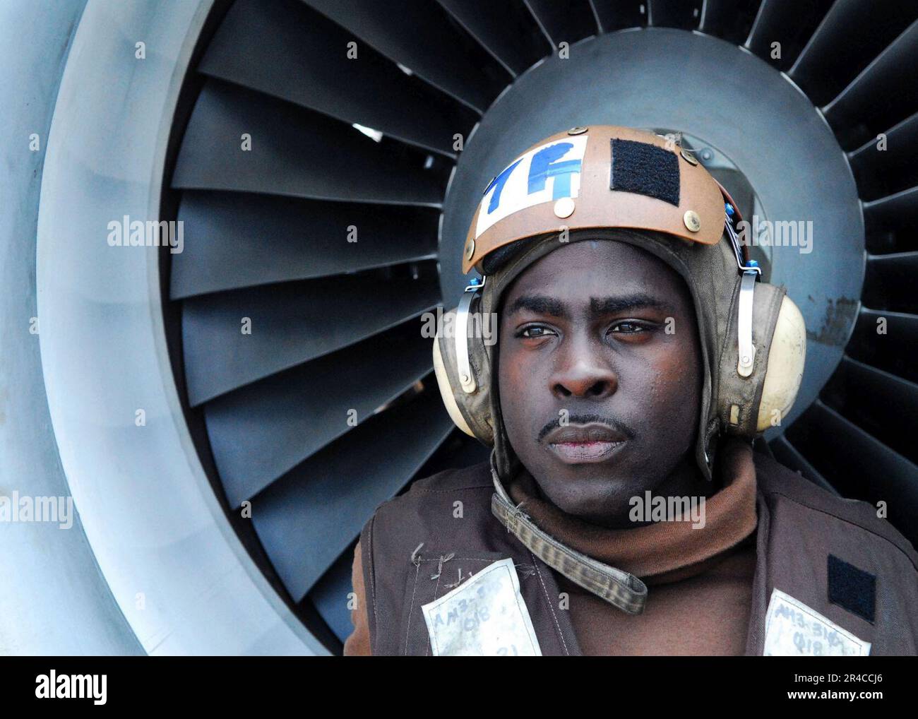 US Navy Aviation Structural Mechanic 3rd Class stands in front of a S ...