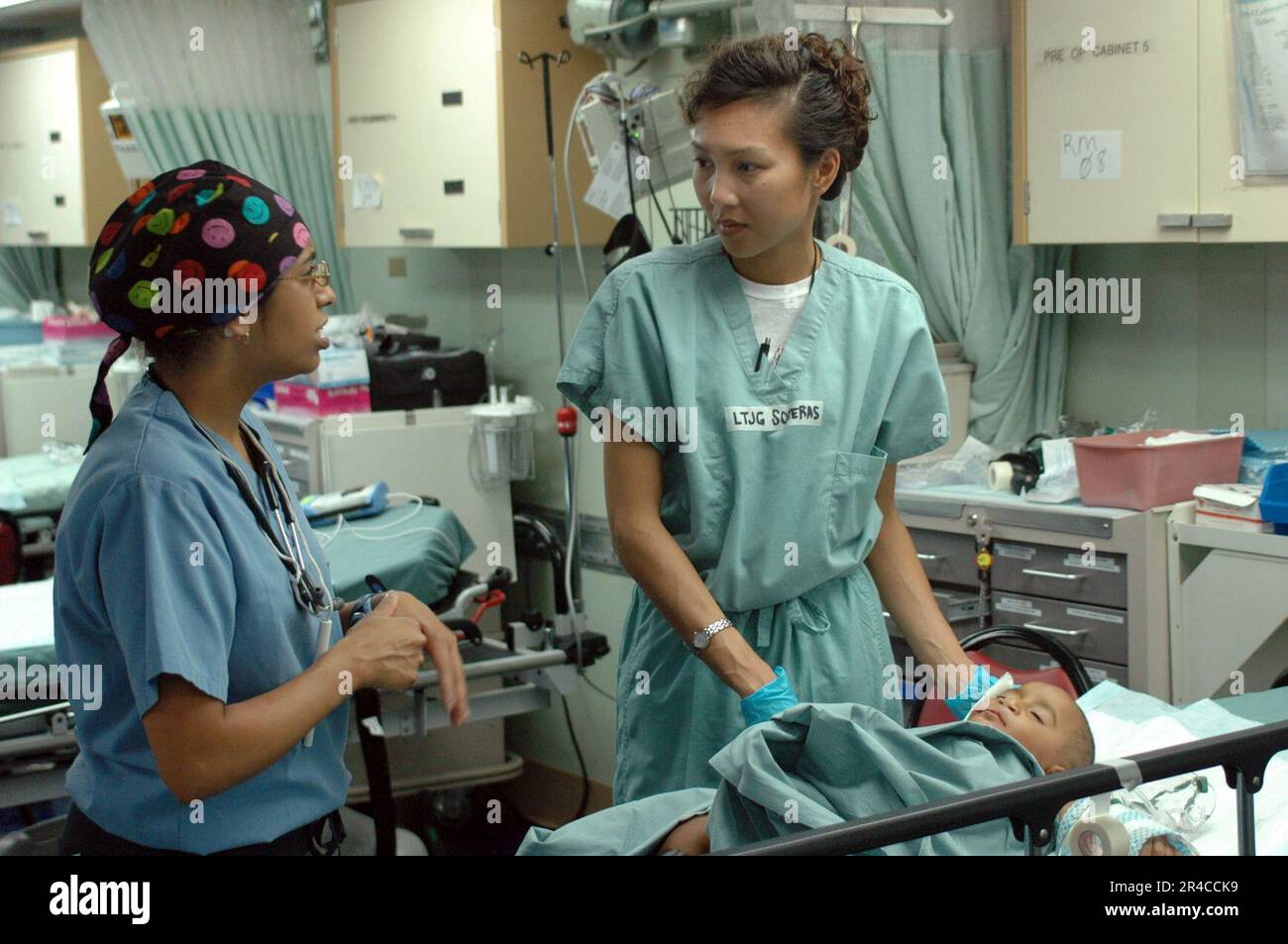 US Navy U.S. Navy Lt.j.g. discuses a patients condition with Operation ...